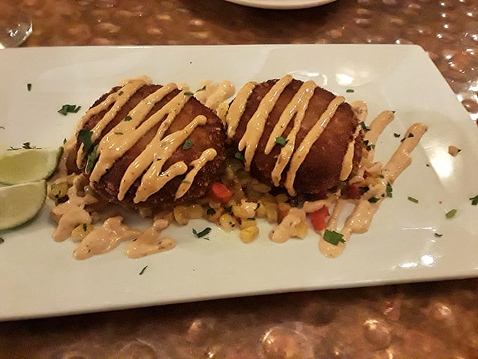 Golden-brown crab cakes that could make Baltimore jealous, drizzled with remoulade and perched atop a bed of colorful corn relish.