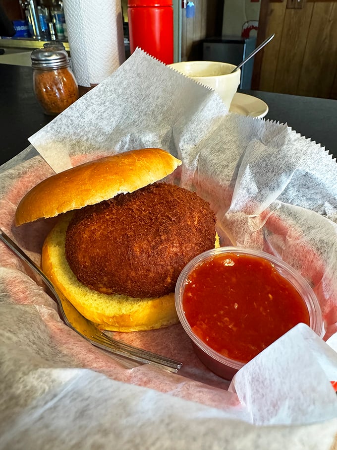 This golden-brown crab cake sandwich isn't trying to impress Instagram—it's too busy impressing your taste buds with sweet, lump crab meat.