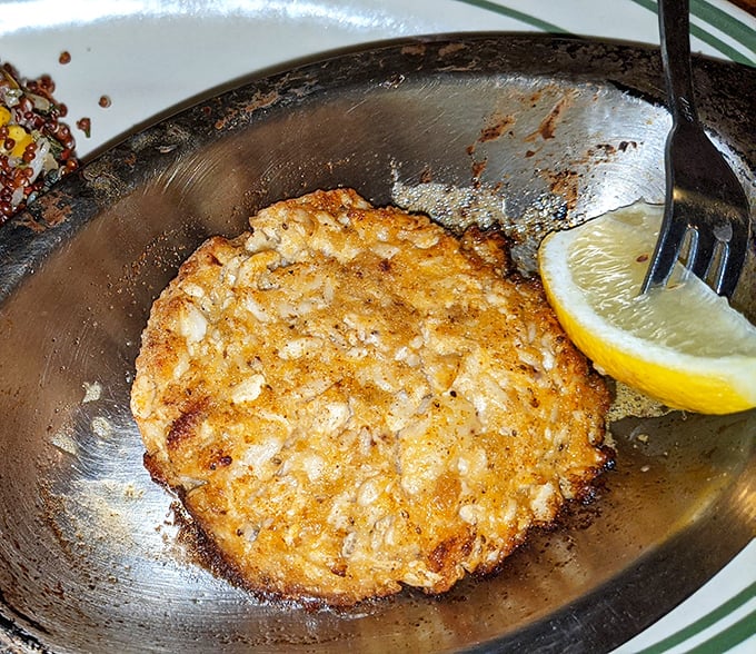 Golden-brown perfection on a plate. This crab cake isn't playing games—it's all about the sweet lump crabmeat with minimal filler and maximum flavor.