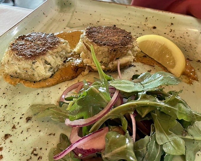 These crab cakes aren't just good, they're life-altering—more crab than cake, with a golden crust that audibly shatters with each fork press.