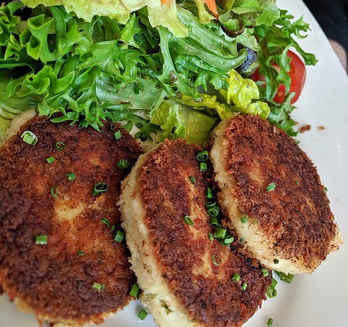 Golden-brown perfection! These crab cakes achieve that mythical balance—crispy exterior giving way to sweet, tender Dungeness crab that makes you momentarily forget your table manners.
