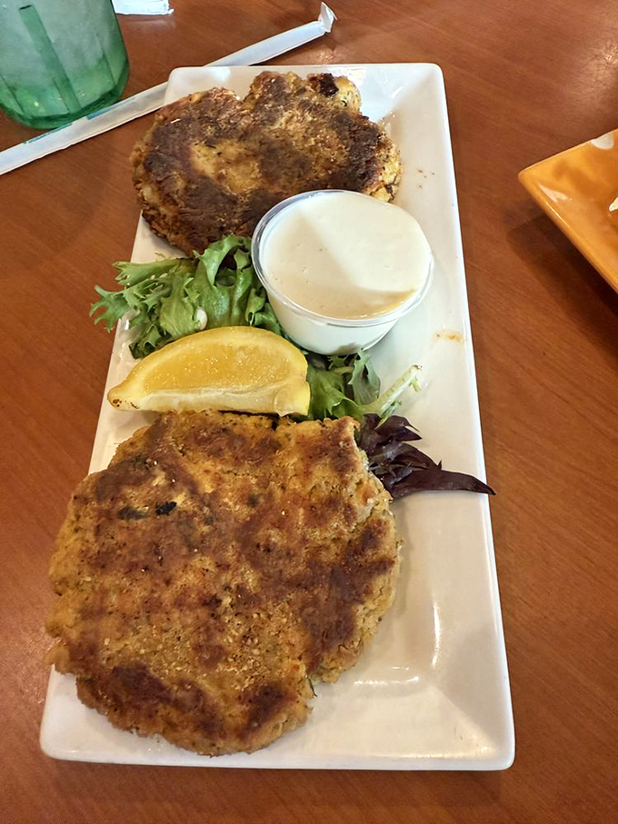 Golden-brown perfection on a plate. These crab cakes are what seafood dreams are made of—minimal filler, maximum flavor, and that key lime sauce!