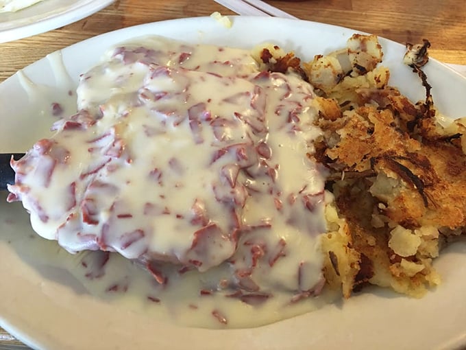 The legendary cream chipped beef in all its glory! Tender dried beef swimming in velvety sauce alongside golden home fries—comfort food that hugs your soul.