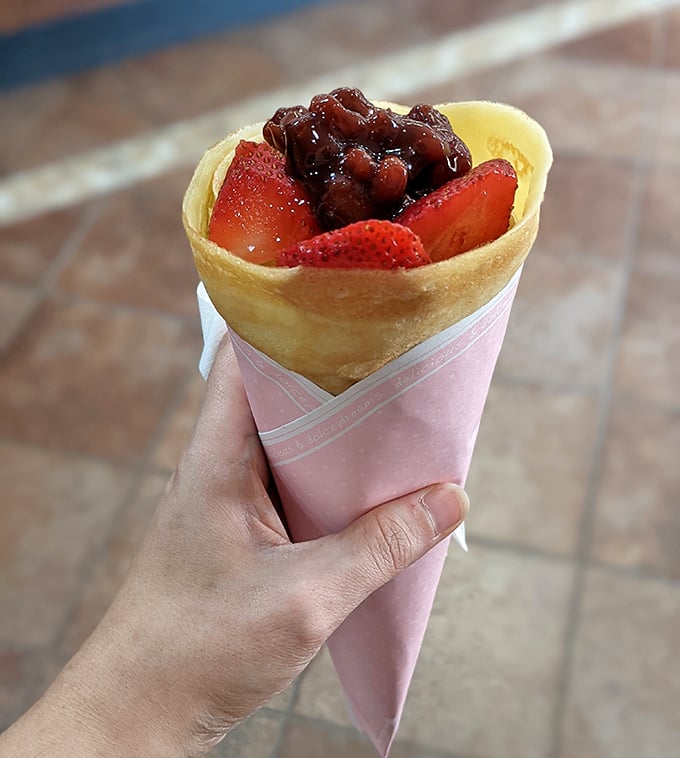 This isn't just a crepe—it's a handheld celebration with red bean paste and fresh strawberries playing the starring roles.