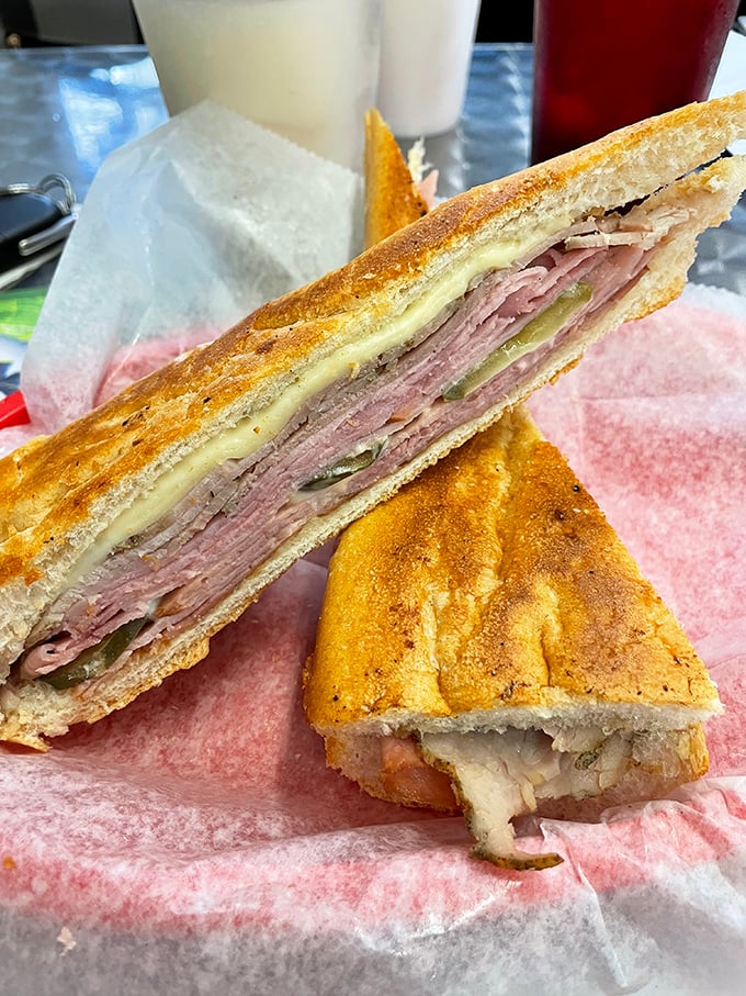 Behold the Cuban sandwich in its natural habitat—layers of pork, ham, and cheese pressed to perfection, like a delicious geological formation millions of tastebuds in the making.