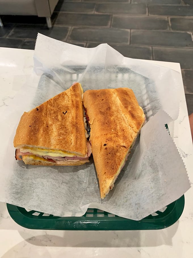 This pressed sandwich isn't just lunch—it's architecture. Golden, crispy exterior giving way to layers of savory goodness that would make a Cuban grandmother nod in approval.