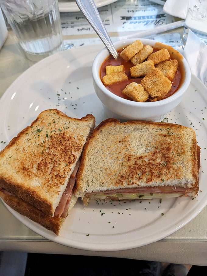 This Cuban sandwich isn't asking for your attention—it's commanding it. The tomato bisque alongside? That's just showing off.