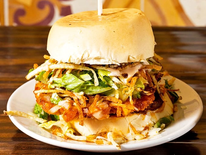 Behold the Big Magic Frita in all its glory—a seasoned patty crowned with crispy shoestring potatoes and fresh toppings that'll make your regular burger jealous.