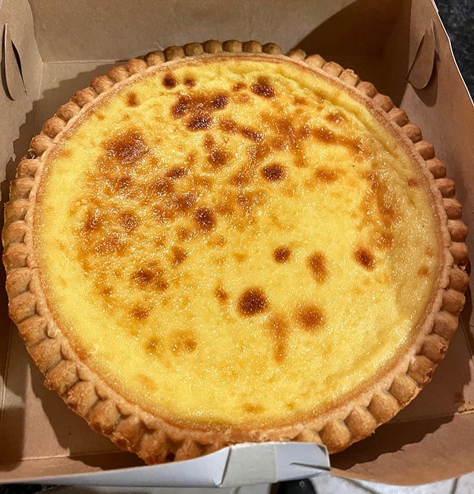 The custard pie glistens with a perfectly caramelized top that crackles under your fork like nature's creme brûlée.