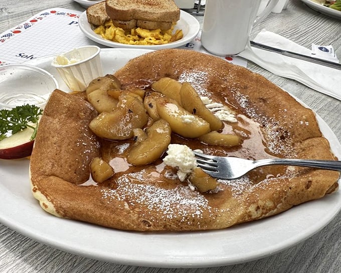 This isn't just a pancake, it's a Danish revelation – thin, golden, and topped with caramelized apples that would make even the most stoic Viking weep with joy.