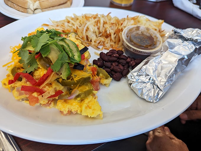 The Denver Omelet arrives like edible artwork – a masterpiece of eggs, peppers, and cheese that makes you want to applaud the chef.