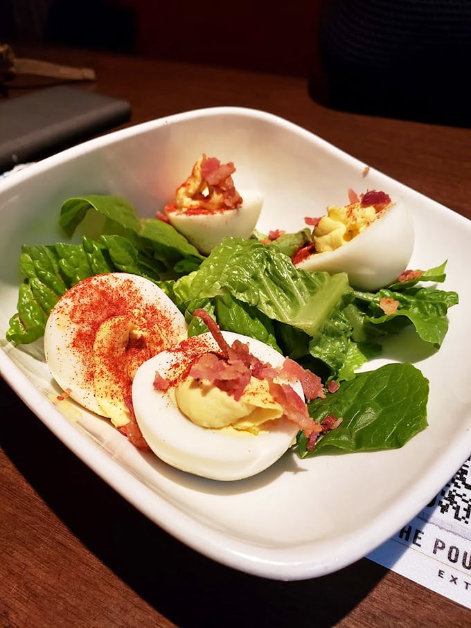Behold the golden gods of appetizers - deviled eggs so perfect they'd make your grandmother slightly jealous but proud.