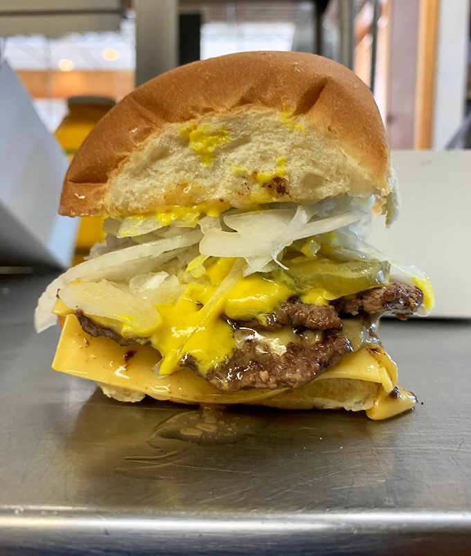 Behold the double cheeseburger in all its glory—where melted cheese cascades over perfectly seared patties like a yellow waterfall of joy.