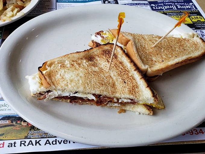 The legendary egg sandwich in all its glory—perfectly toasted bread embracing eggs and bacon like old friends at a reunion. Worth driving across county lines for.