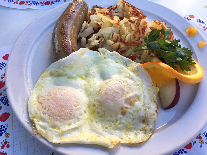 Sunny-side up perfection alongside crispy hash browns and Danish sausage – a breakfast trinity that proves sometimes the classics just can't be improved upon.