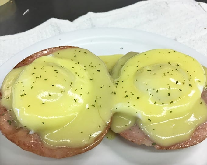 Eggs Benedict isn't just breakfast—it's a golden-hued masterpiece where perfectly poached eggs meet hollandaise in a morning romance that would make Shakespeare weep.