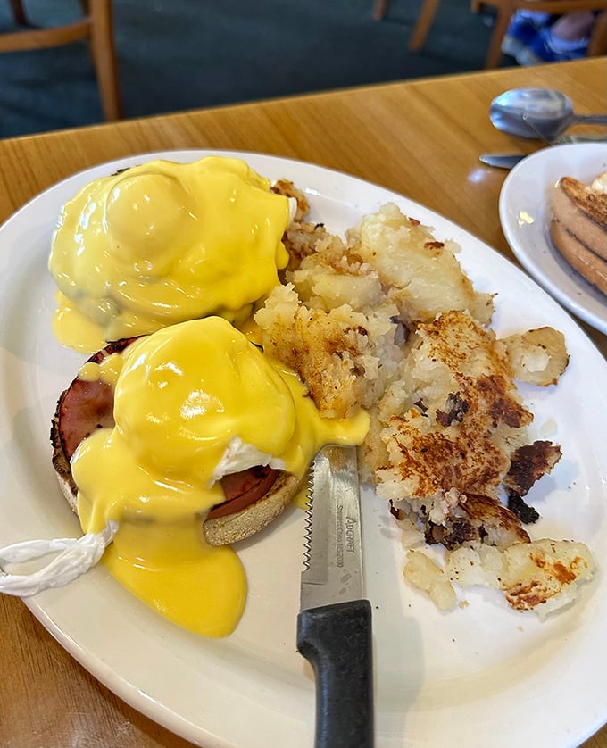This is the Eggs Benedict that launches a thousand weekend drives – golden hollandaise perfection.