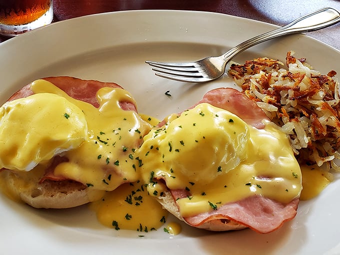 Behold, the holy grail of breakfast: eggs Benedict with hollandaise so golden and luxurious it deserves its own Swiss bank account. Those hash browns aren't playing second fiddle either.