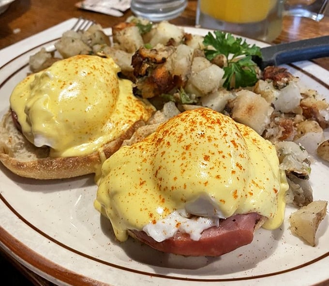 Behold the Benedict that launched a thousand return trips – perfectly poached eggs, velvety hollandaise, and those home fries that refuse to be upstaged.