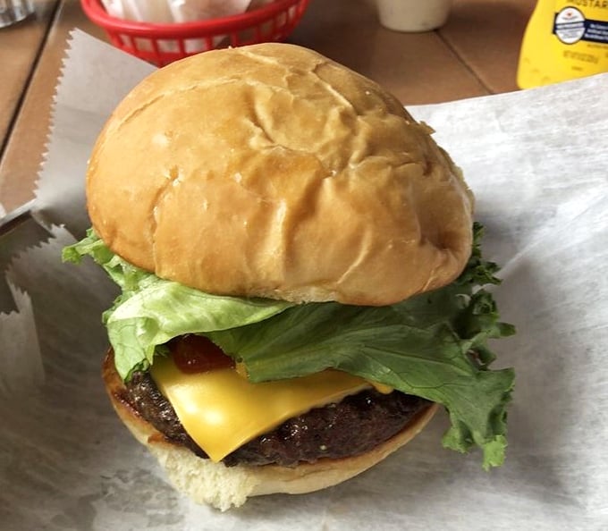 This isn't just a burger—it's edible architecture. Notice how the melted cheese creates the perfect foundation for that garden-fresh lettuce.