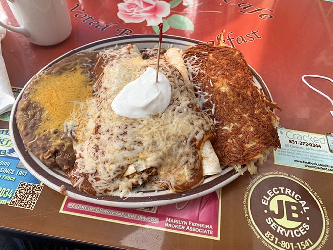 Behold the breakfast enchilada in all its glory! Cheese-blanketed tortillas swimming in red sauce with that perfect dollop of sour cream.