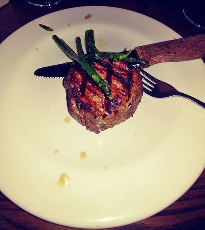 This filet mignon isn't just a steak; it's a masterpiece of meat minimalism, perfectly charred outside and tender enough to cut with a whisper.