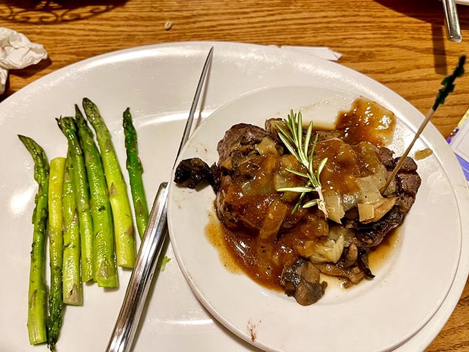 This isn't just filet mignon—it's a masterclass in meat preparation, complete with asparagus standing at attention like delicious green soldiers.