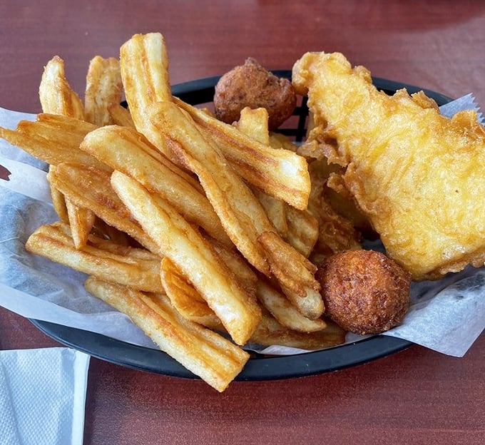 Golden-battered fish that shatters with each bite, alongside chips that could make a Londoner homesick. This is edible nostalgia.