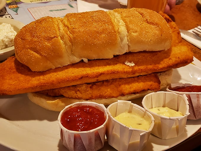 Behold the mythical fish sandwich in its natural habitat—bread struggling valiantly to contain fish that's determined to make a grand entrance.