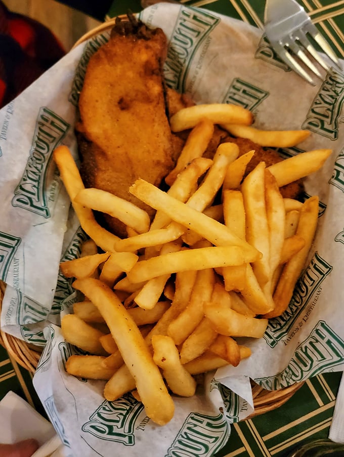 Golden-battered haddock resting on a bed of perfectly crisp fries – this isn't just fish and chips, it's edible poetry wrapped in Plymouth's signature paper.