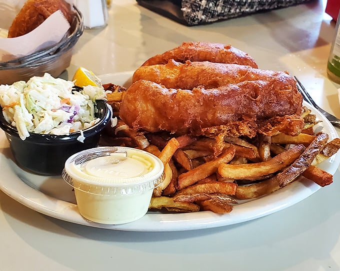 Golden-battered fish that shatters with each bite, revealing pearly white flesh beneath. This isn't just fish and chips—it's edible architecture.