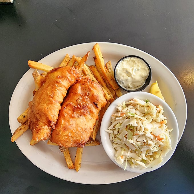Golden-battered fish that shatters with each bite, nestled among fries that could make a Frenchman weep. The coleslaw isn't an afterthought—it's essential balance.