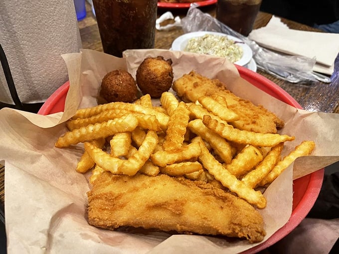 Golden fried fish nestled next to crinkle-cut fries and hush puppies – the holy trinity of seafood dining.