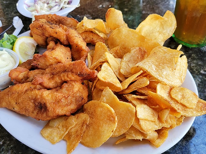 Golden-battered fish with chips piled high like a delicious Jenga tower. This is what seafood dreams are made of.