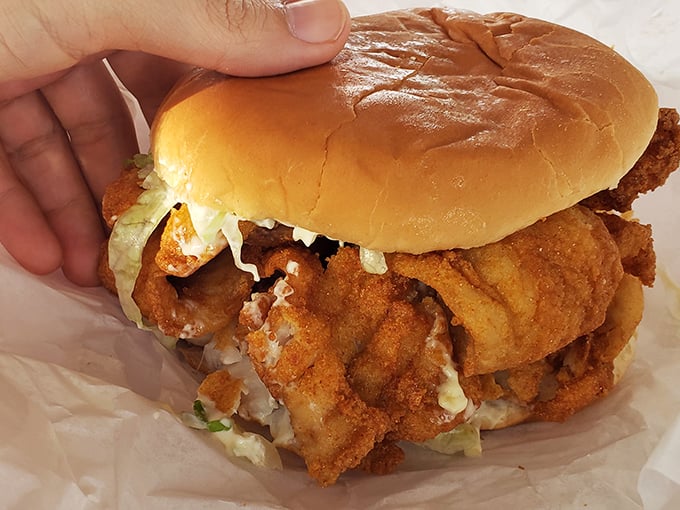 Behold the star attraction: golden-fried fish spilling beyond its bun boundaries. This sandwich doesn't just satisfy hunger—it creates food memories that last for years.