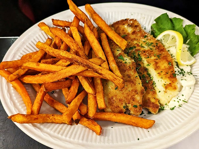 The star of the show: perfectly golden fried white fish with crispy sweet potato fries. A plate that makes you want to high-five the chef.