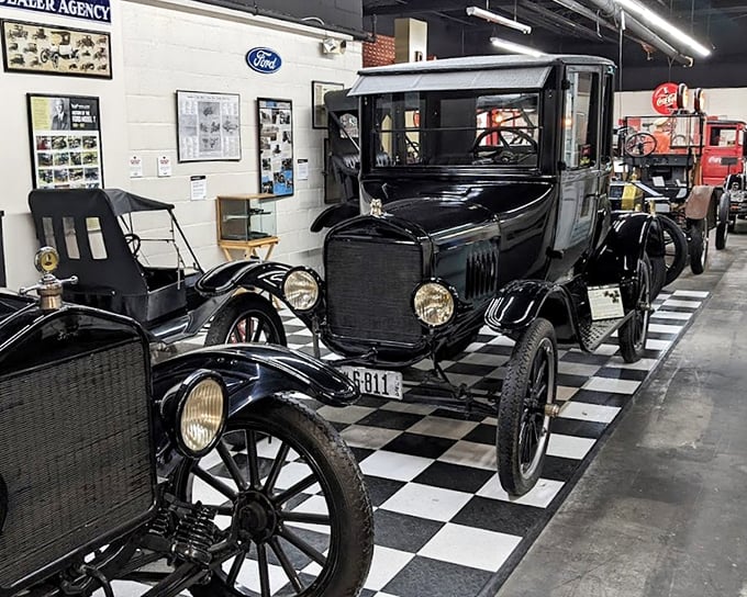 Henry's vision in black—a row of Model Ts stands at attention on a classic checkered floor, reminding us when "any color as long as it's black" was revolutionary thinking.