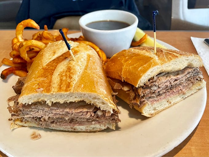 This French dip sandwich isn't just lunch—it's an architectural marvel of tender meat and crusty bread that demands to be dunked with reckless abandon.