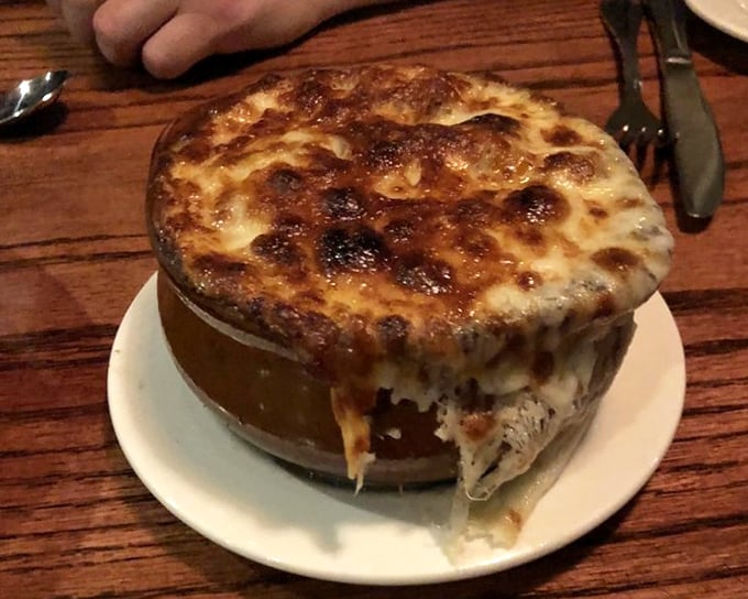 This French onion soup isn't just bubbling with cheese—it's practically performing a Broadway musical number right there on your table.