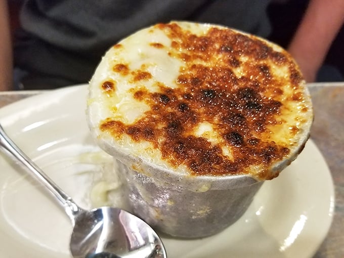 Behold the crown jewel: French onion soup with a cheese canopy that stretches like a dairy-based bungee cord. This bubbling masterpiece should require a permit.