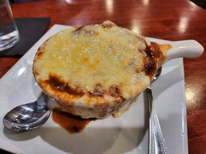 Behold the legendary French onion soup that makes people drive across Pennsylvania – golden cheese perfection awaits.