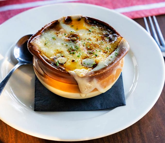 This isn't just French onion soup—it's a masterpiece of bubbling cheese, rich broth, and bread that's soaked up decades of culinary wisdom.