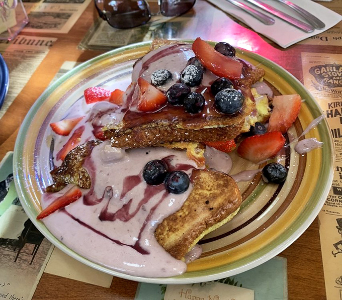 Berry-crowned French toast that makes pancakes jealous. That berry sauce isn't just drizzled—it's applied with the precision of a Renaissance painter finishing a masterpiece.