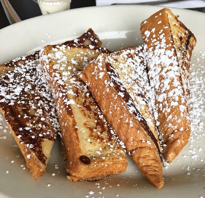 Golden-brown challah French toast dusted with powdered sugar—proof that sometimes the simplest pleasures are the most transcendent.