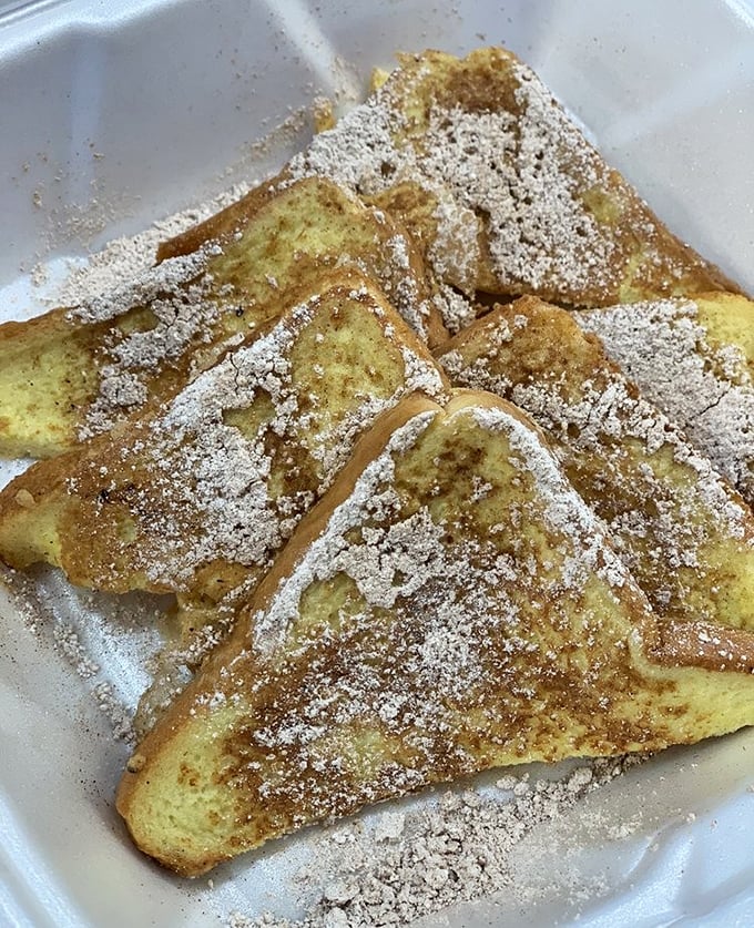 French toast that makes you question all your life choices—why haven't you been eating this every morning? Powdered sugar dusting like fresh snow on golden perfection.
