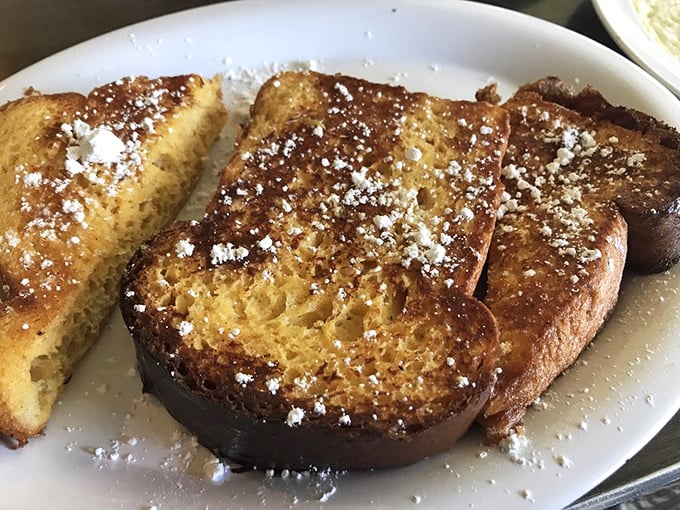 Golden-brown French toast dusted with powdered sugar—proof that simplicity, when executed perfectly, can outshine the fanciest culinary creations on earth.