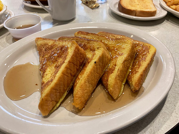 Golden triangles of French toast glistening with syrup – this isn't just breakfast, it's the reason alarm clocks were invented.