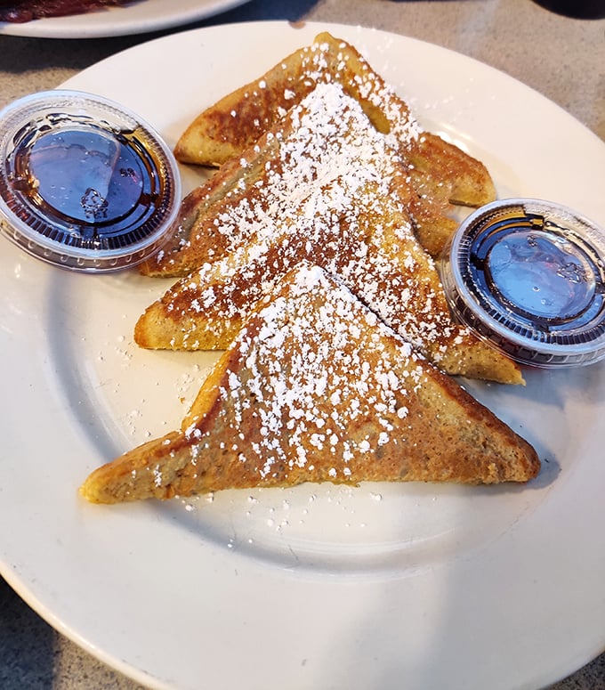 The star of the show: Quinn's French toast dusted with powdered sugar and served with syrup—simple perfection on a plate.