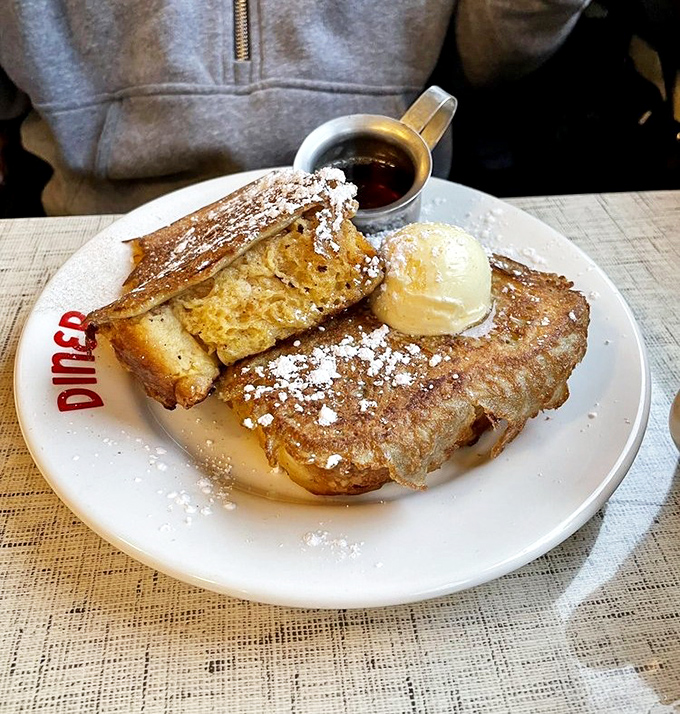 French toast so photogenic it deserves its own social media account, complete with that glorious powdered sugar snowfall.