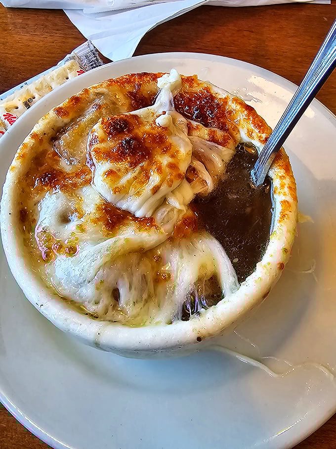 Behold the star attraction—French onion soup with a cheese pull that deserves its own Instagram account. Spoon-breaking cheese crust included.